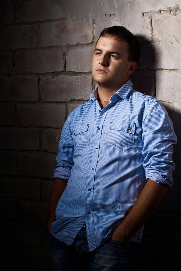 Sad guy against wall stock photo. Image of person, shirt - 26312782