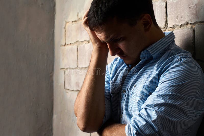 Sad guy against wall stock photo. Image of depressed - 26313030