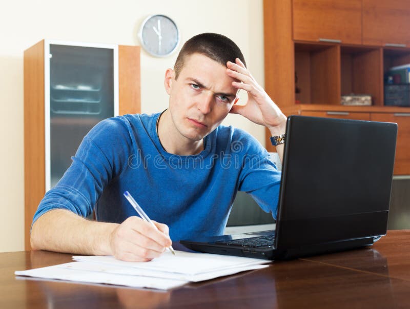 Sad Guy with Laptop and Financial Documents at Home Interior Stock ...