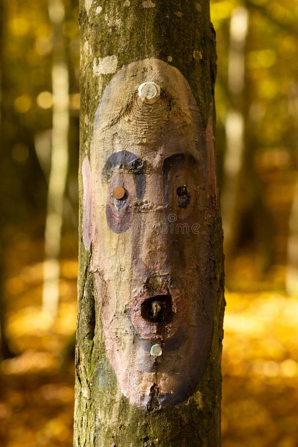 A Sad Human Face in the Form of an Icon is Painted on the Trunk of a ...