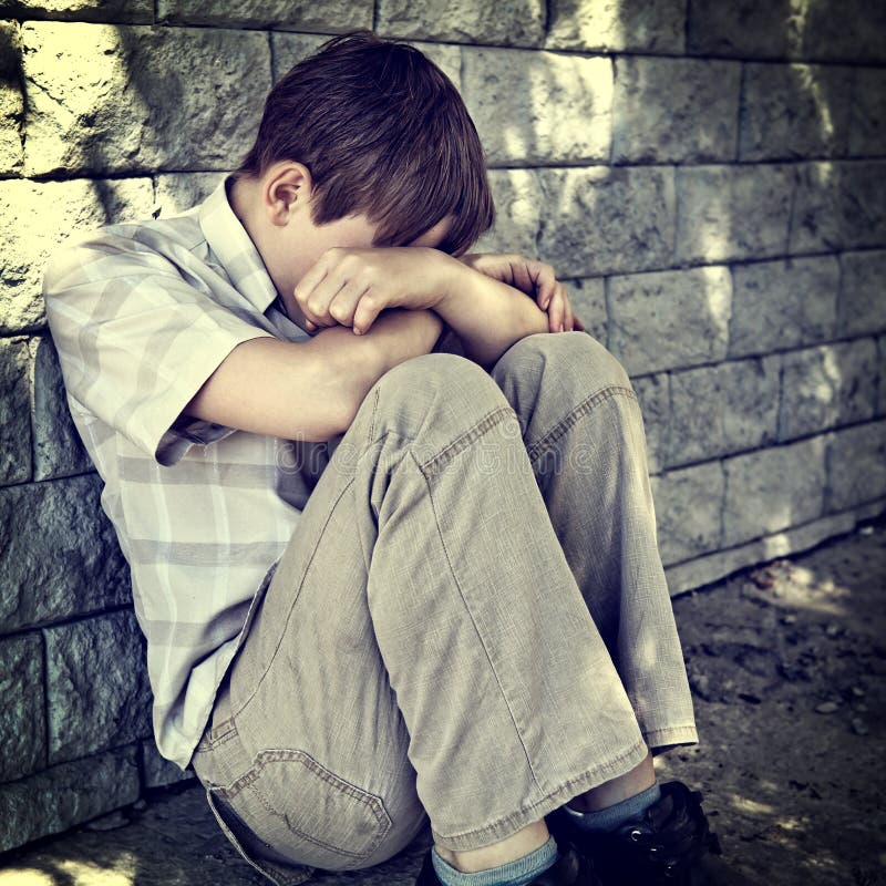 Photo Of Sad And Stressed Kid Sit By The Wall Outdoor Stock Image ...