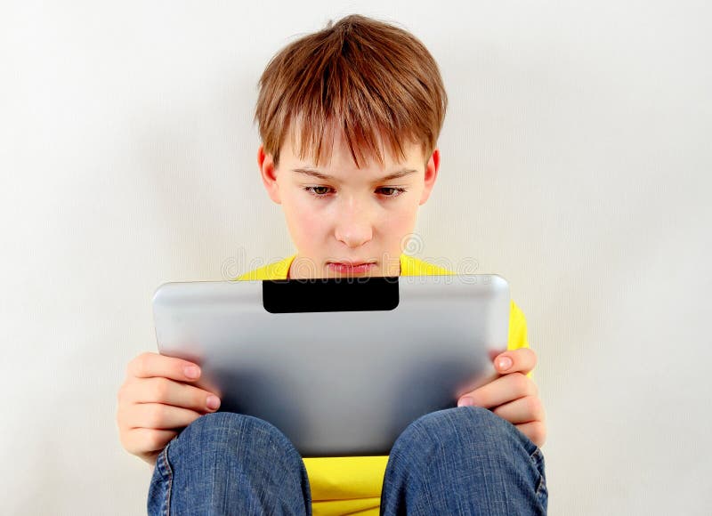 Sad Kid with Tablet stock image. Image of hands, device - 82351935