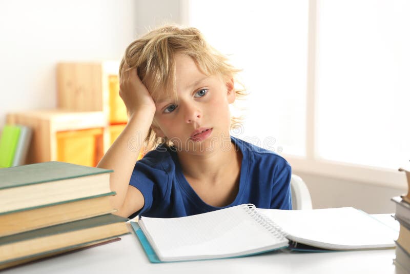 Sad Little Boy Doing Homework at Table Indoors Stock Photo - Image of ...