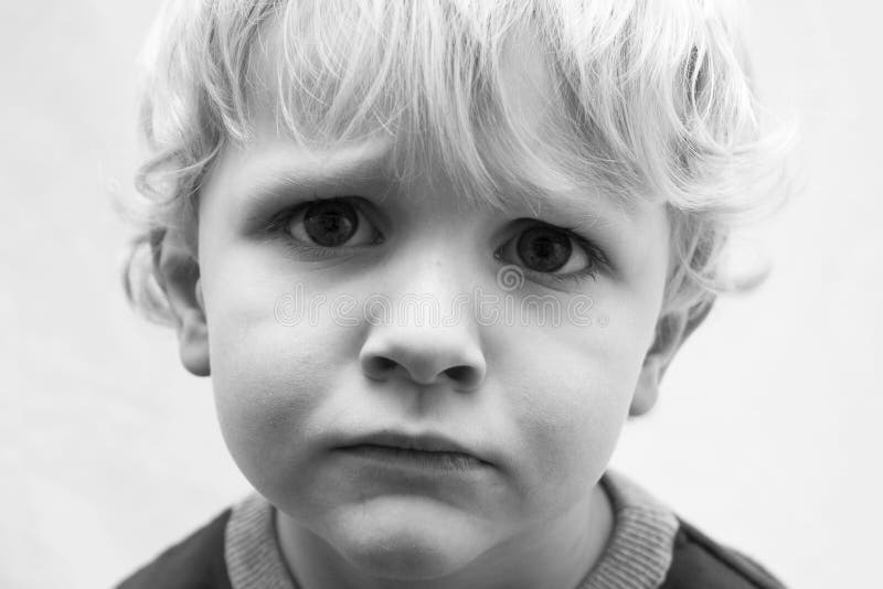 Sad Little Boy stock photo. Image of cute, frown, black - 67478730