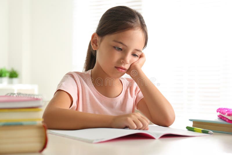 Sad Little Girl Doing Homework at Table Indoors Stock Image - Image of ...