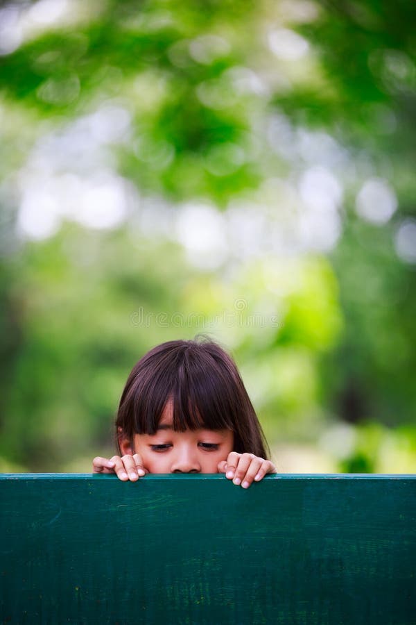Sad girl on bench stock photo. Image of little, grass - 6129414