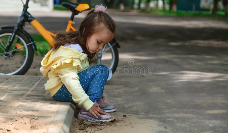 Little Girl Fell Off Her Bike and Holds Her Bruised Leg with Her Hands ...