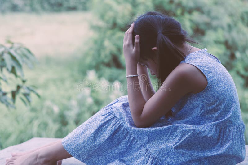 Sad Little Girl Sitting with Hands Holding the Head Stock Photo - Image ...