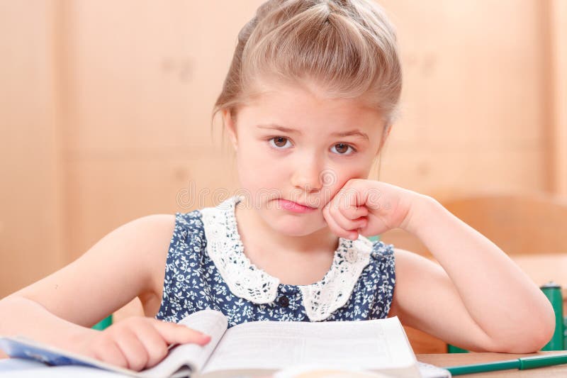 Sad little reading girl stock photo. Image of alone, book - 53593256
