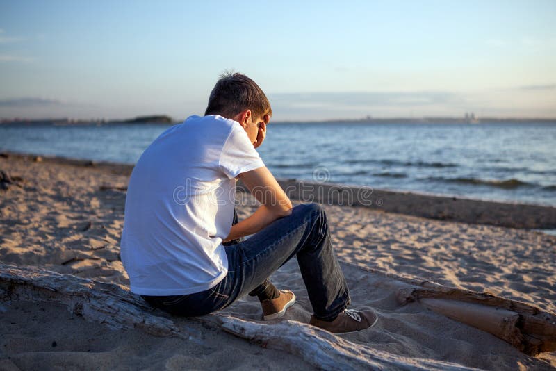 Sad Young Man stock photo. Image of nature, side, ocean - 105573208