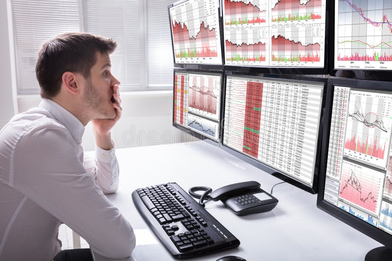 Sad Male Operator Looking at Graphs on Multiple Computer Screen Stock ...