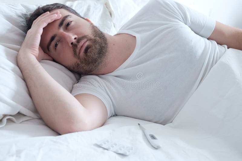 Sad man lying in the bed stock photo. Image of divorce - 79031122