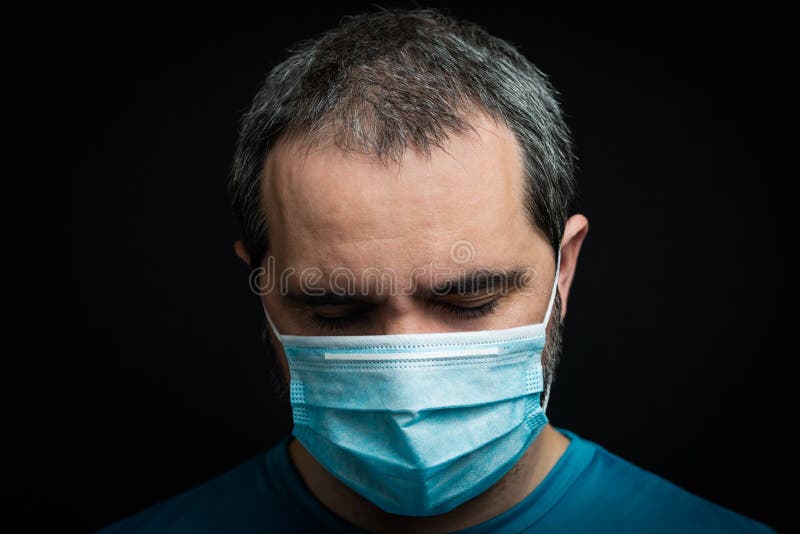 Sad Man with Medical Mask on Black Background. Man Looking Down Stock ...