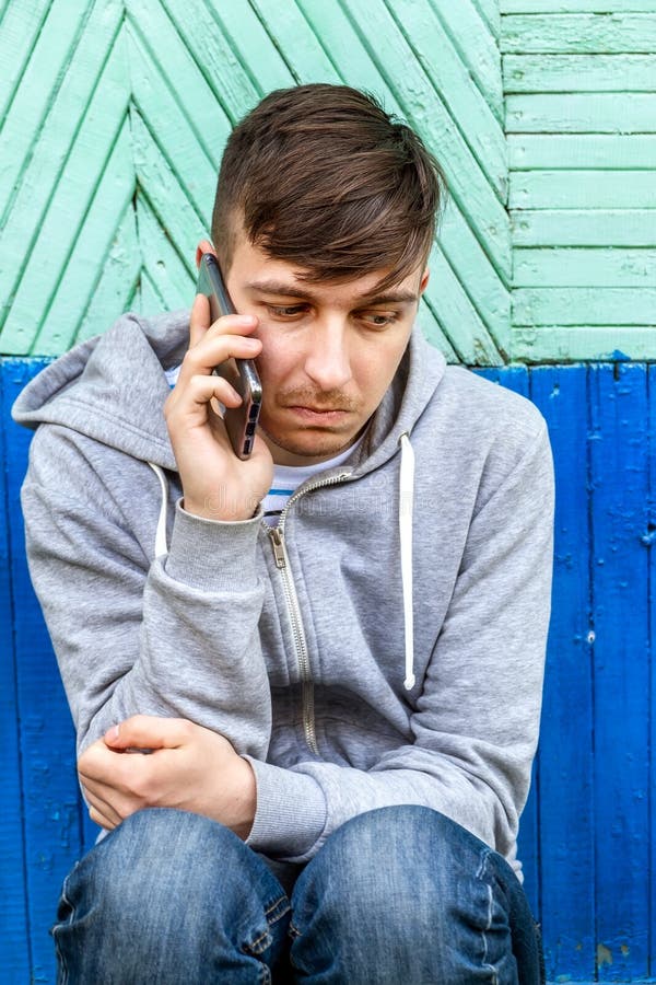 Sad Man with a Phone stock image. Image of outside, cellphone - 217299547