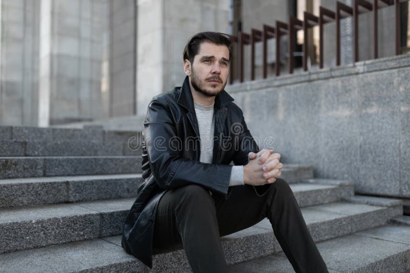 Sad Man Sits on the Steps with Sadness Looks Ahead Stock Photo - Image ...