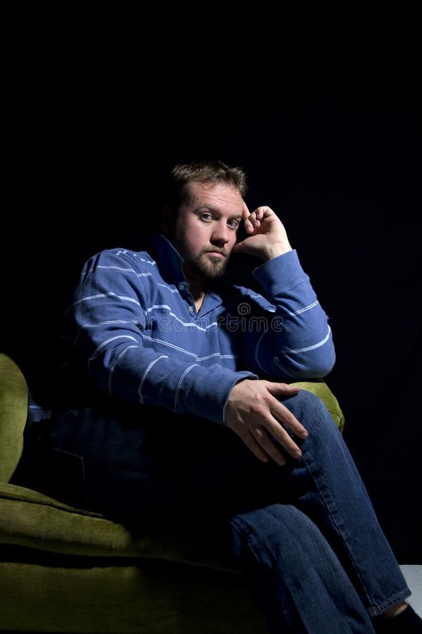 Sad Man Sitting on a Chair stock image. Image of male - 14037609