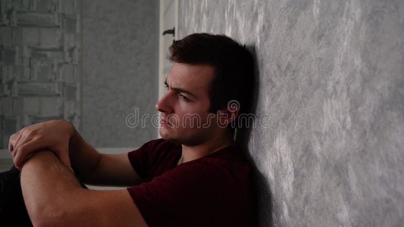 Sad Man Sitting in the Corner of the Wall Stock Video - Video of ...