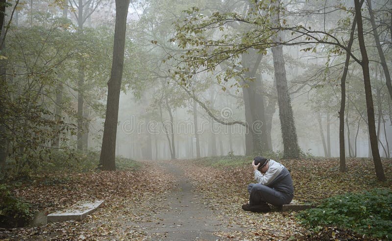 Sad Man Sitting In The Forest Stock Image - Image: 62385593