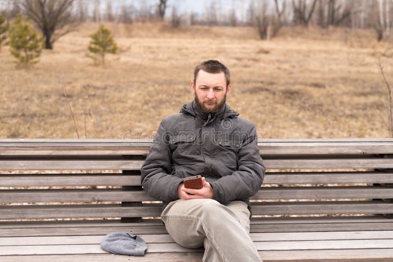Sad Man with Smartphone on a Bench Stock Image - Image of serious ...