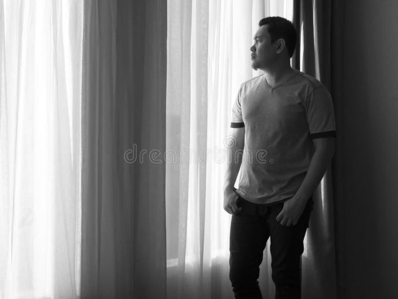 Sad Man Standing Next To Window in Dark, Looking with Empty Look ...