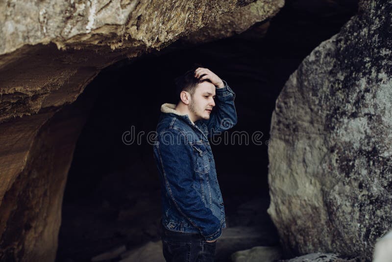 Sad Man Stands in a Dark Cave. the Concept of Loneliness Stock Photo ...