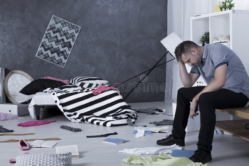 Sad man surrounded by mess stock photo. Image of aged - 82186860