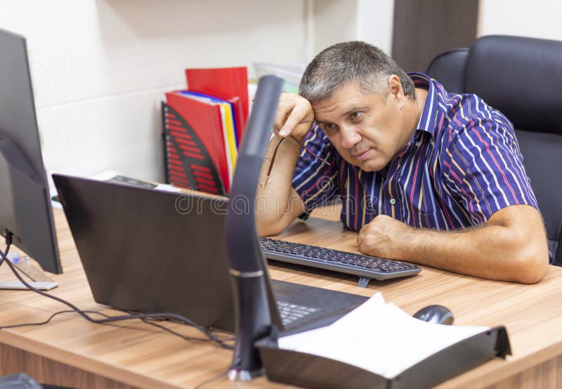 Sad Middle Aged Man in Front of Laptop in Office. Stock Photo - Image ...