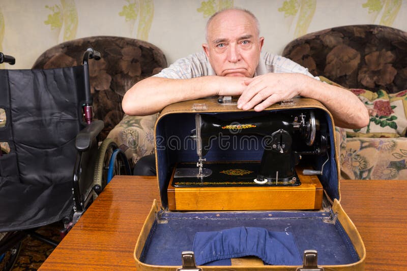 Sad Old Man Leaning on a Sewing Machine in a Case Stock Photo - Image ...