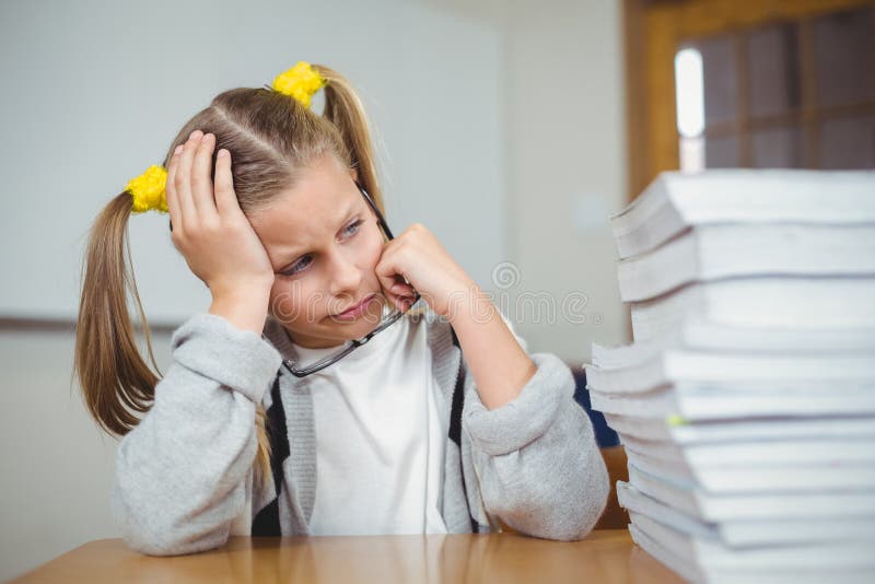 Sad Pupil Sitting at Her Desk in a Classroom Stock Photo - Image of ...
