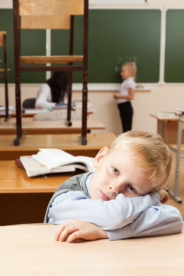 Sad schoolboy in classroom stock photo. Image of depression - 46000804