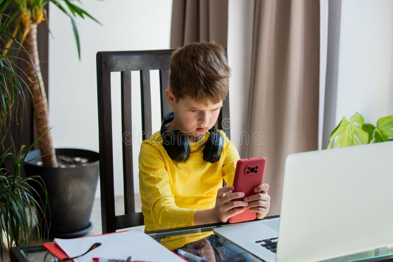 Sad Schoolboy in Headphones Learning Via Computer at Home Stock Image ...
