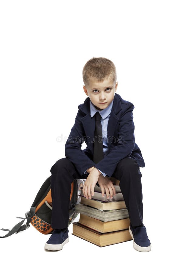 A Sad Schoolboy Sits on a Pile of Books. Learning Difficulties ...