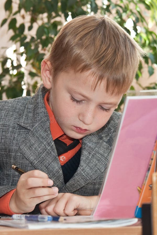Sad Schoolboy Writing in a Copybook Stock Photo - Image of exam ...