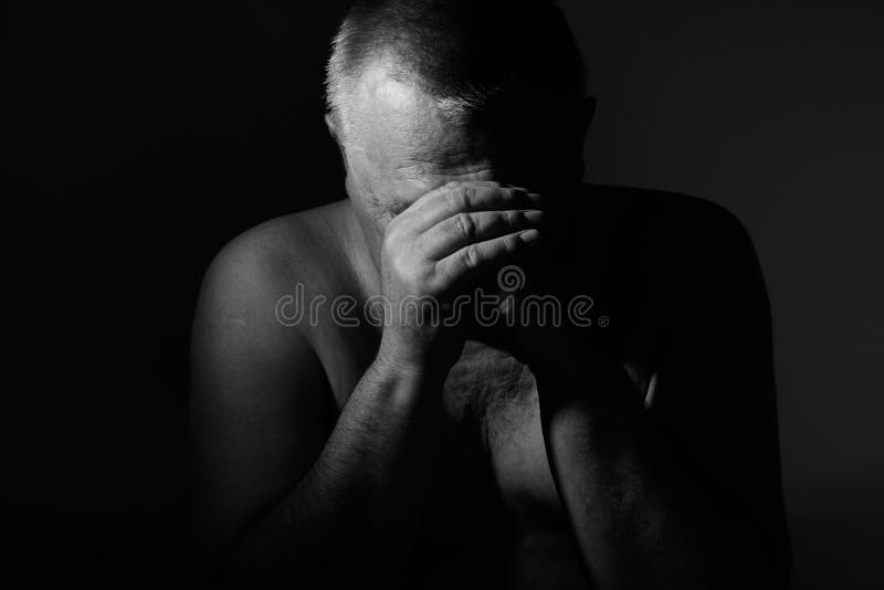 Sad Senior Man with Hands on Face Over Black Stock Photo - Image of ...