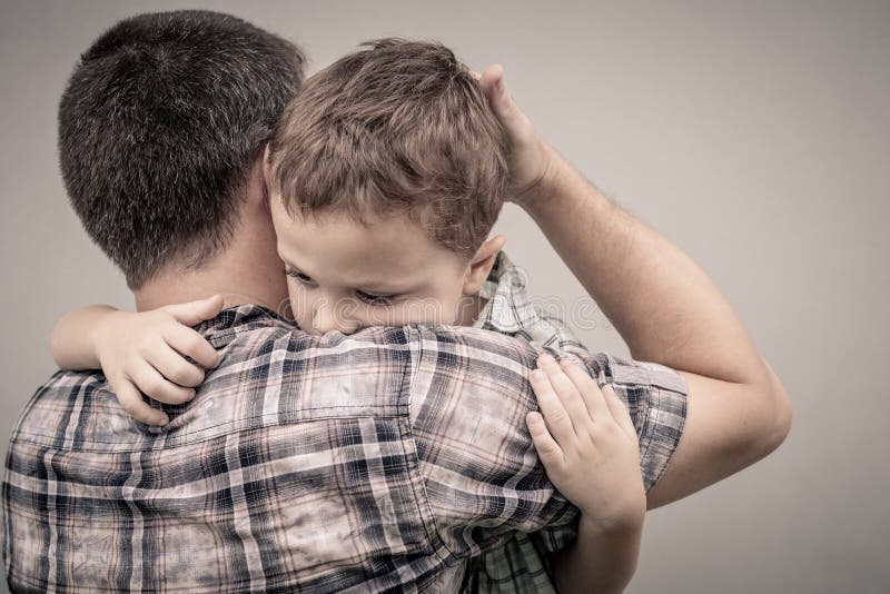 Sad son hugging his dad stock image. Image of offspring - 58303481