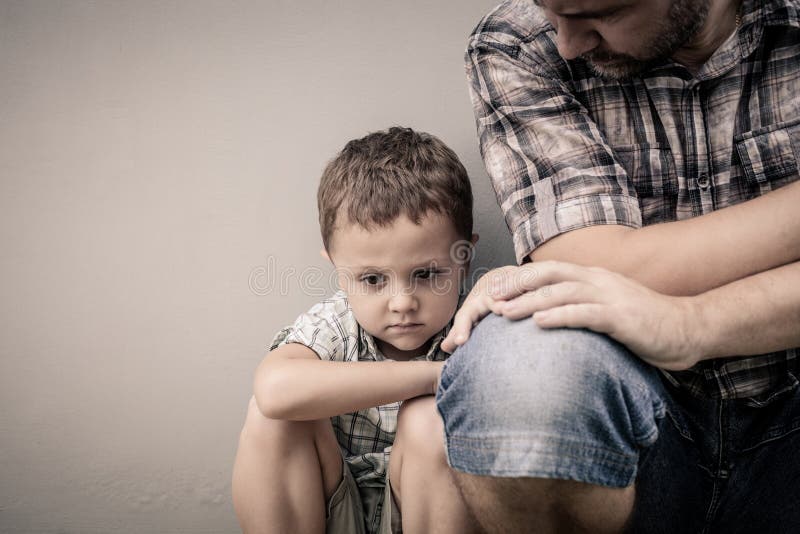 Sad son hugging his dad stock photo. Image of pain, help - 58303590