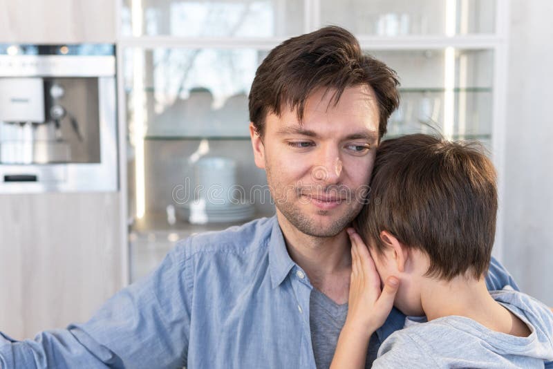 Sad son hugging his father stock photo. Image of grief - 211095146