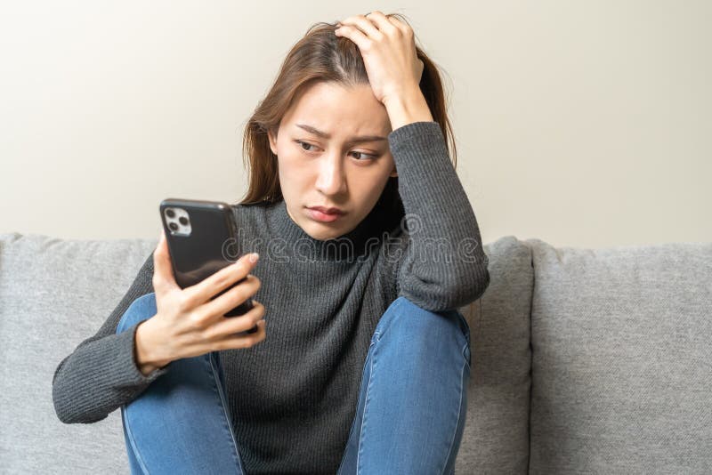 Sad, Sorrow Asian Young Woman Looking at Screen on Mobile Phone ...