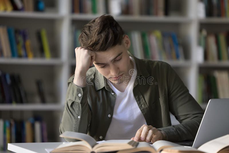 Student Guy Studying in Library Feels Bored or Tired Stock Image ...