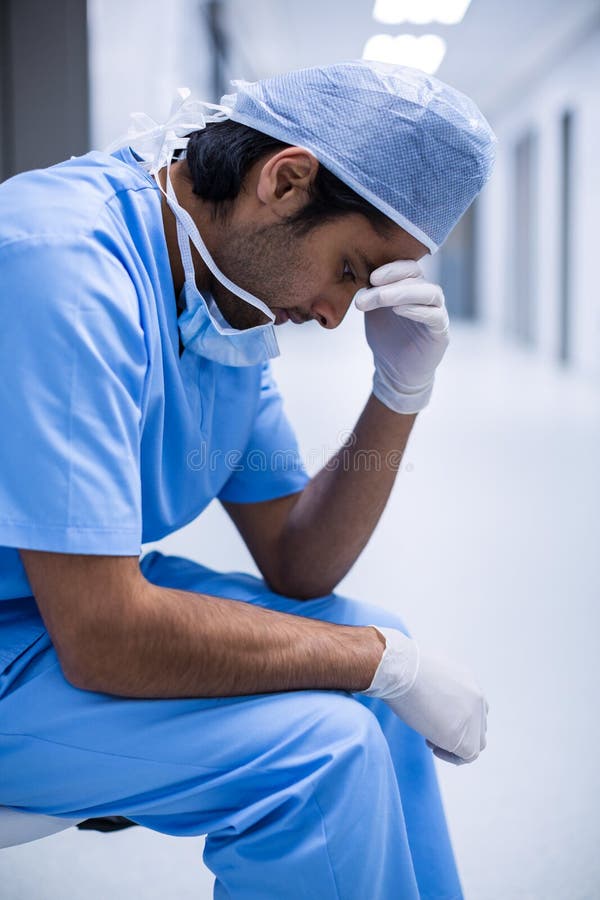 Sad Surgeon Sitting on a Chair Stock Image - Image of adult, corridor ...