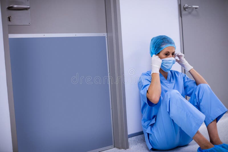 Sad Surgeon Sitting on Floor in Corridor Stock Image - Image of care ...