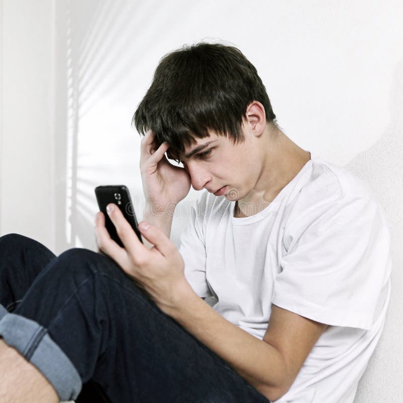 Sad Teenager with Cellphone Stock Image - Image of mobile, couch: 47990679