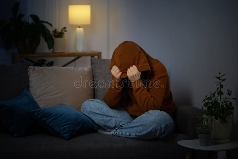Sad Teenager Sitting on Couch Indoor at Night Stock Photo - Image of ...