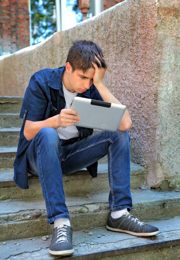 Sad Teenager with Tablet Computer Stock Photo - Image of palmtop ...