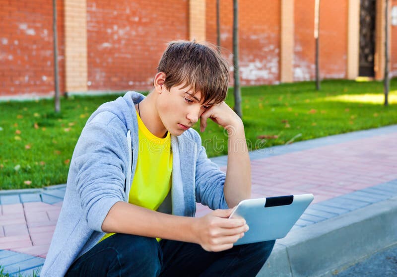 Sad Teenager with Tablet stock photo. Image of cute, face - 85193230