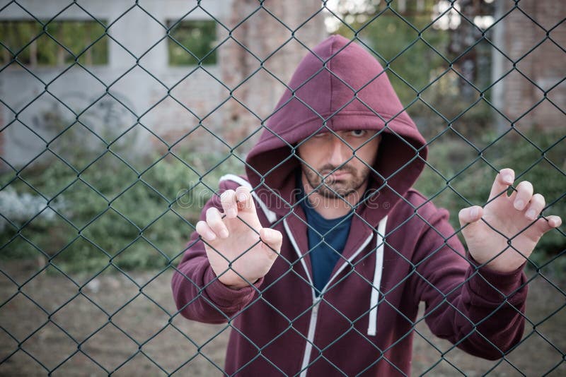 Sad and Troubled Boy Against Metal Fence Stock Photo - Image of fence ...
