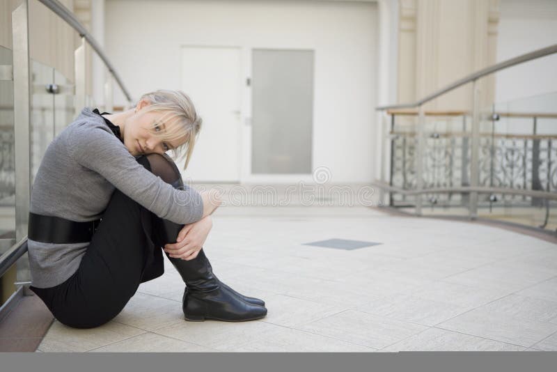 Sad Woman Sitting on Floor at Big Store Stock Photo - Image of blond ...