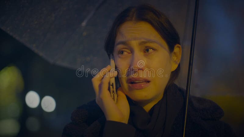 Sad Woman Talking on Cell Phone Outside at Night in Raining Weather ...