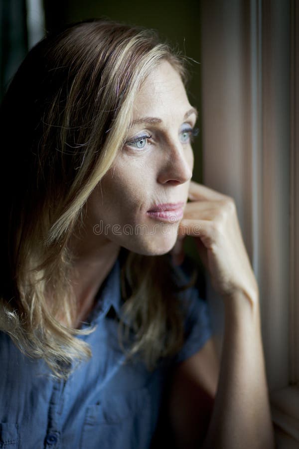 Sad Woman at the Window stock image. Image of closeup - 33858749
