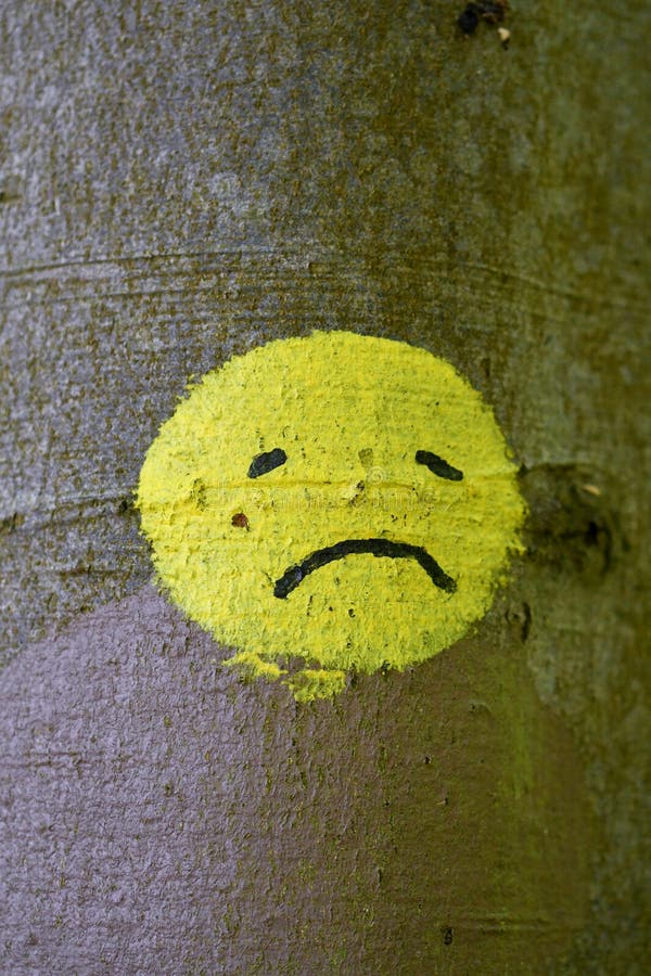 A Sad Yellow Smiley Face Painted on a Tree Stock Image - Image of cute ...